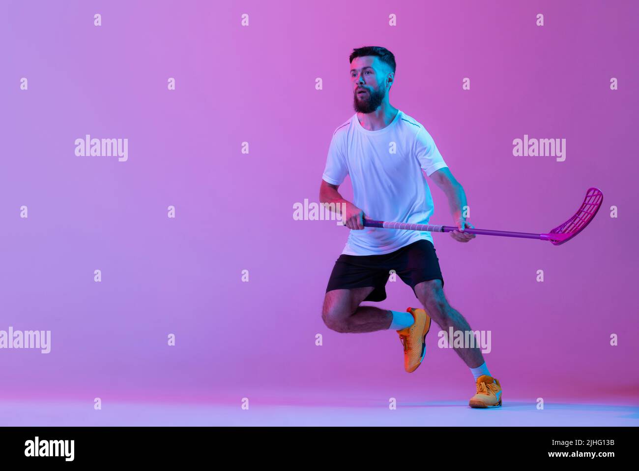 One sportive man, floorball player with floorball stick training ...