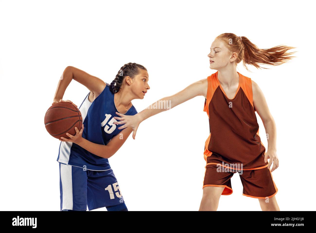 Studio shot of beginner basketball players, young girls, teen training ...