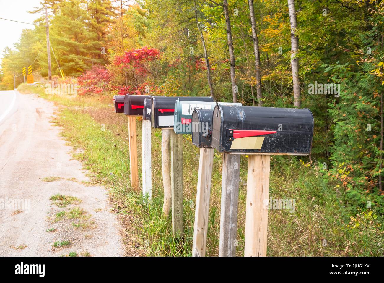 Row of old metal mailboxes along a country road in autumn. Ontario ...