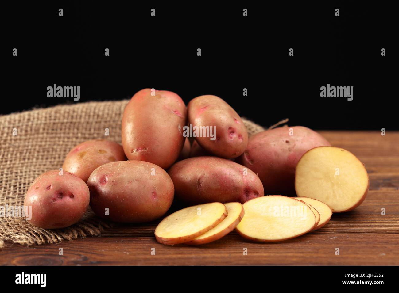 Pile of potatoes lying on wooden boards Stock Photo - Alamy