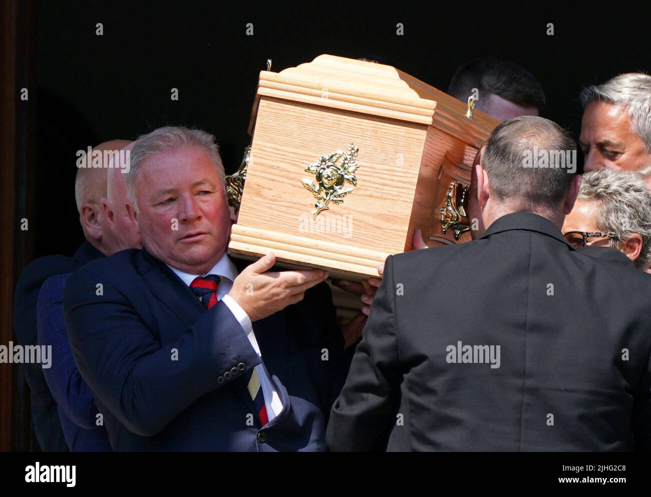 Former Rangers players Ally McCoist (front left) carries the casket ...