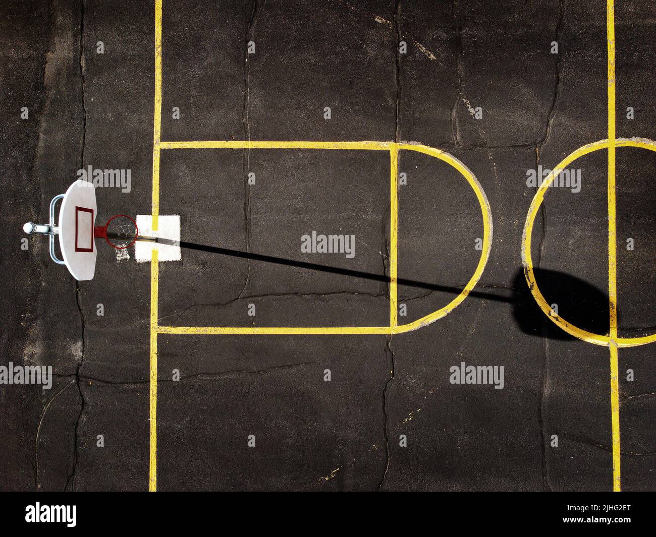 Aerial view from a drone flying above an outdoor urban basketball park ...