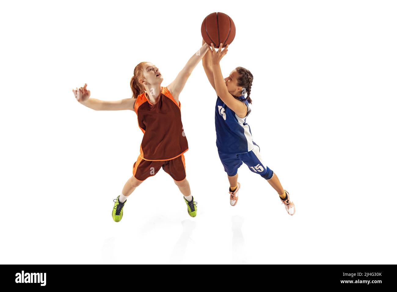 Play defense. Two basketball players, young girls, teen training with ...