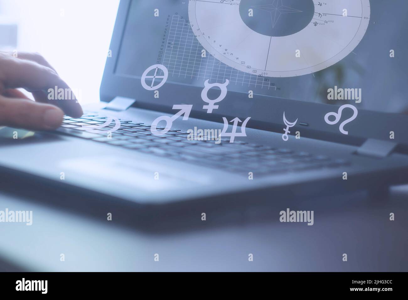 The workplace of a modern advanced astrologer. Laptop on the table for ...