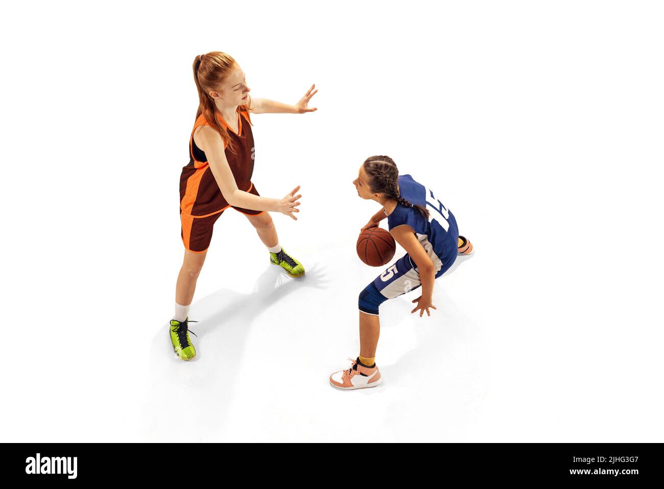 Play defense. Two basketball players, young girls, teen training with ...