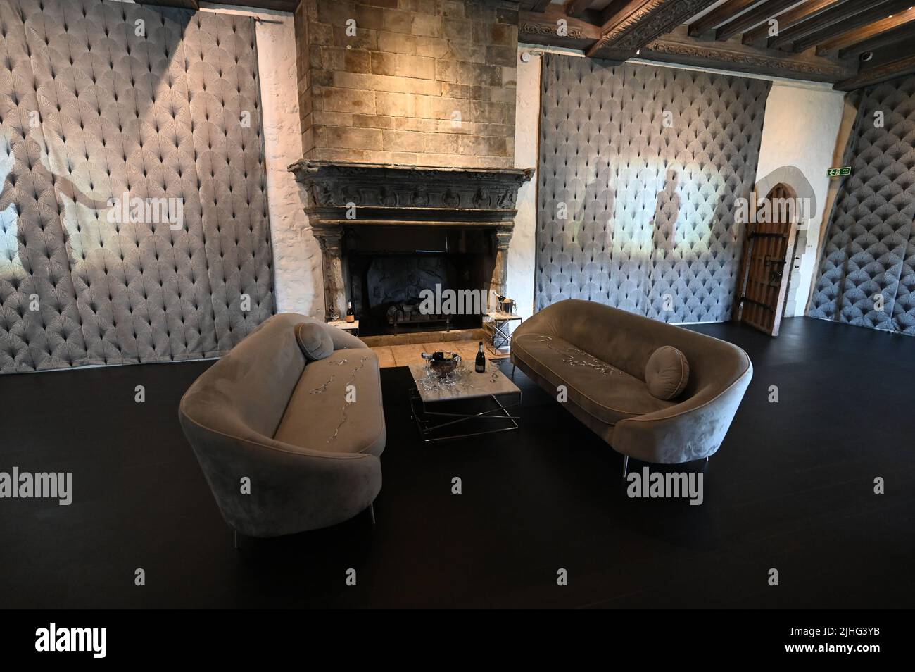 Sofa's by a fireplace at Leeds Castle Stock Photo - Alamy