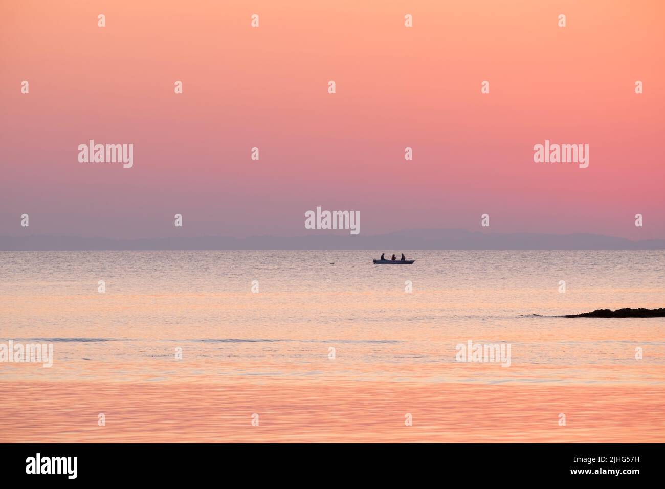 Seascape with a fishing boat heading out to the sea Stock Photo - Alamy