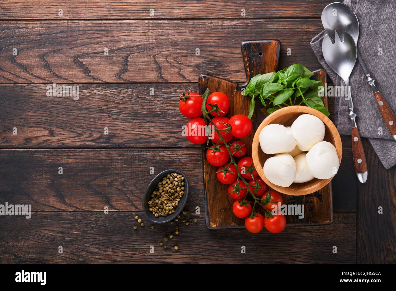 Caprese salad, ingredients for cooking. Cutting wooden board with ...
