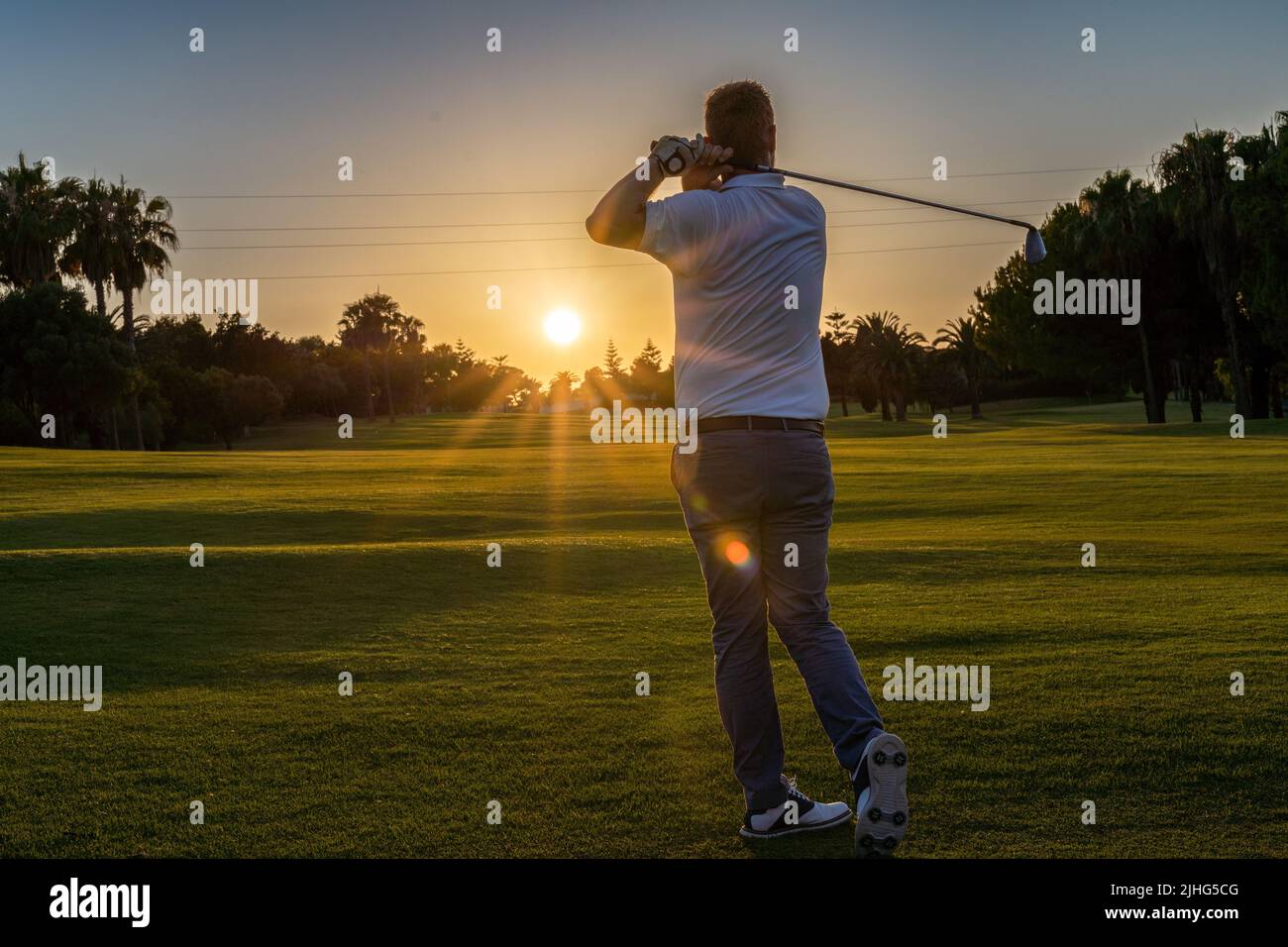 Good strike, professional golfer looking trajectory of the ball, golfer ...
