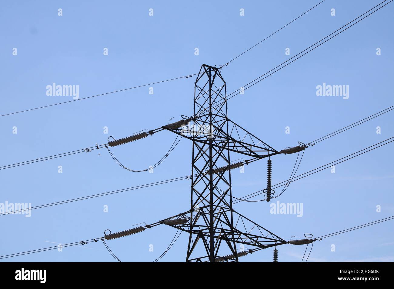 Full frame image of electricity pylon and wires against blue sky Stock ...