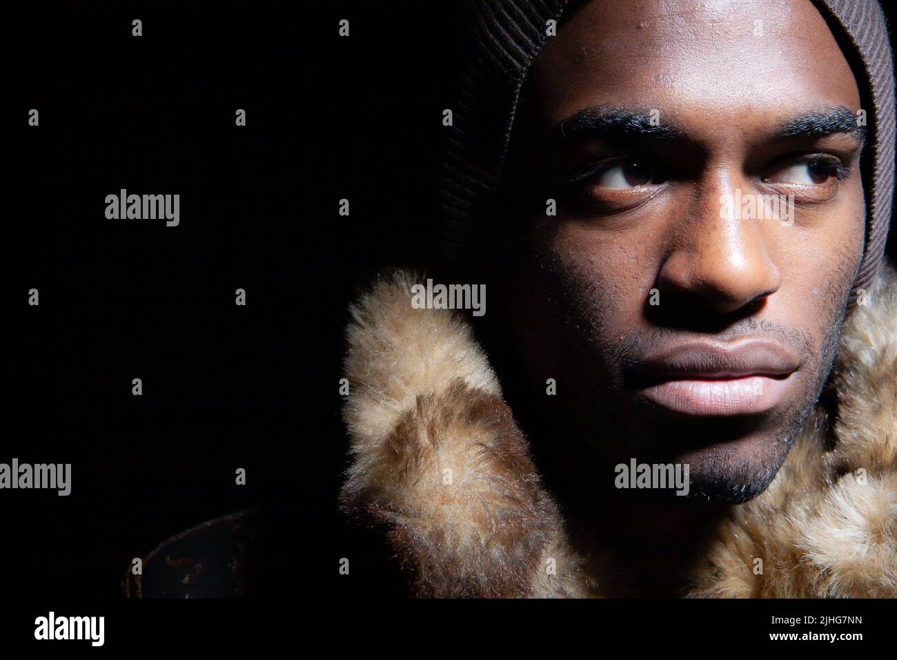 Urban male. A glance away from the camera by a young black male model ...