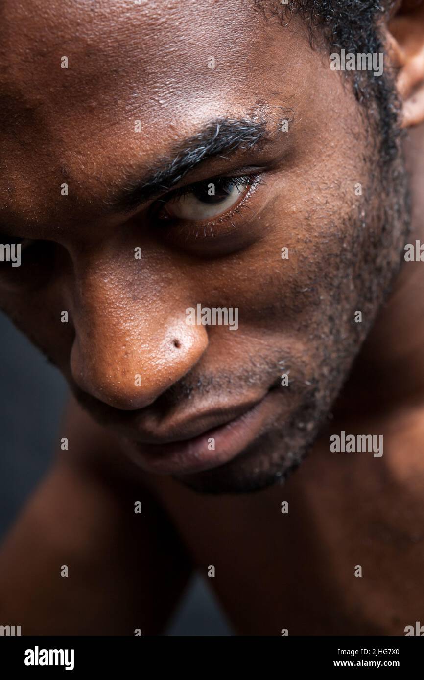 Capoeira artist. A handsome young black male model looking confidently ...