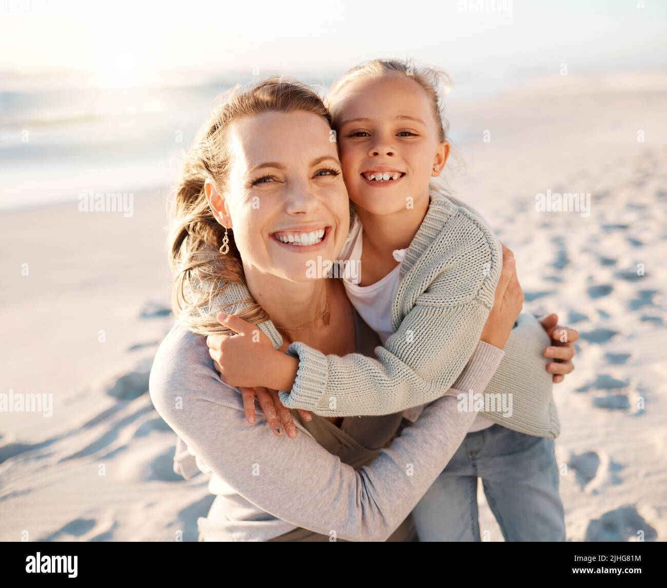 Happy mother hugging daughter beach hi-res stock photography and images ...
