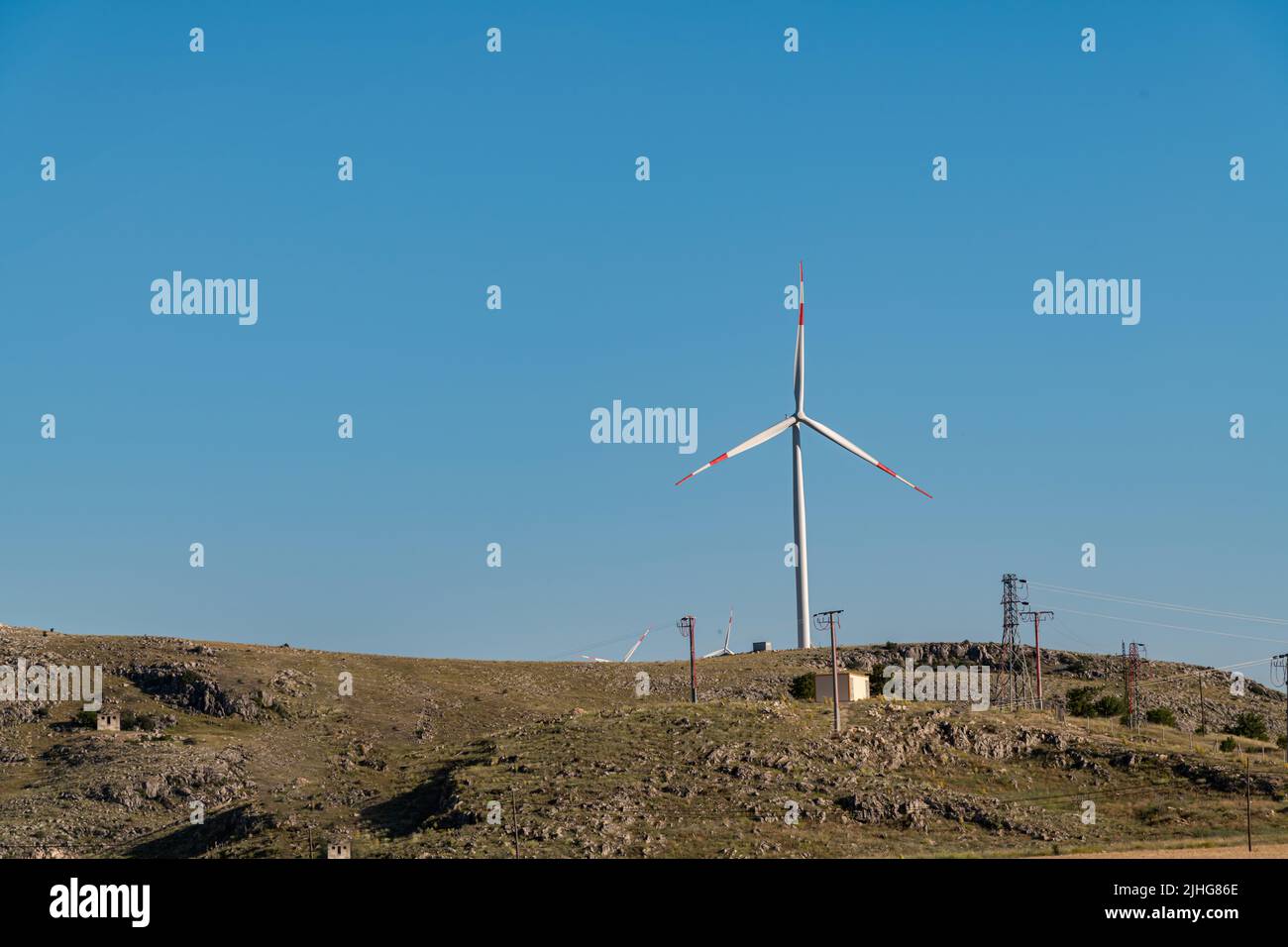 clean electricity producing wind turbine or windmill built on a windy ...