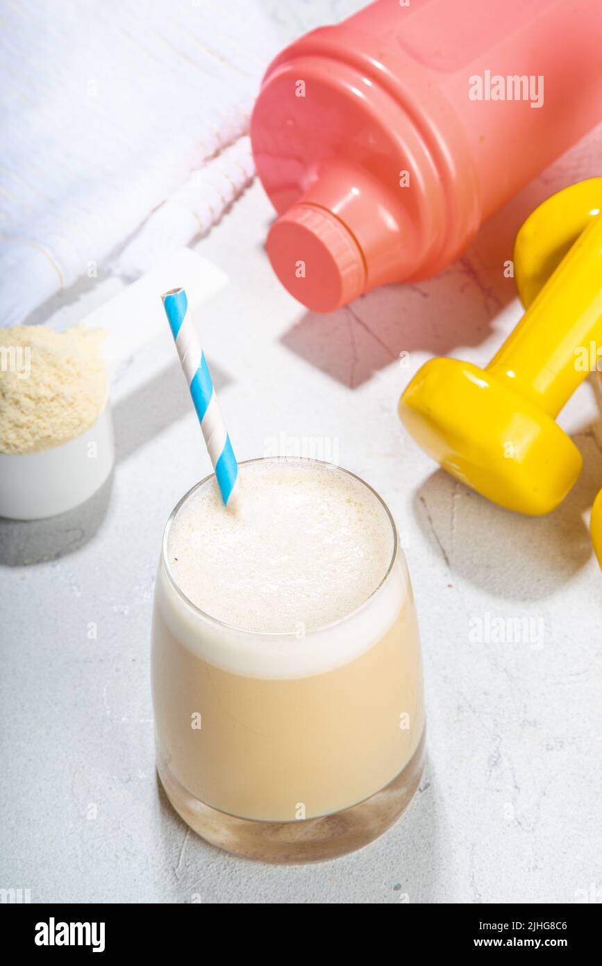 Vanilla White Protein Shake Glass With Straw With Protein Powder Dumbbell Towel And Fitness