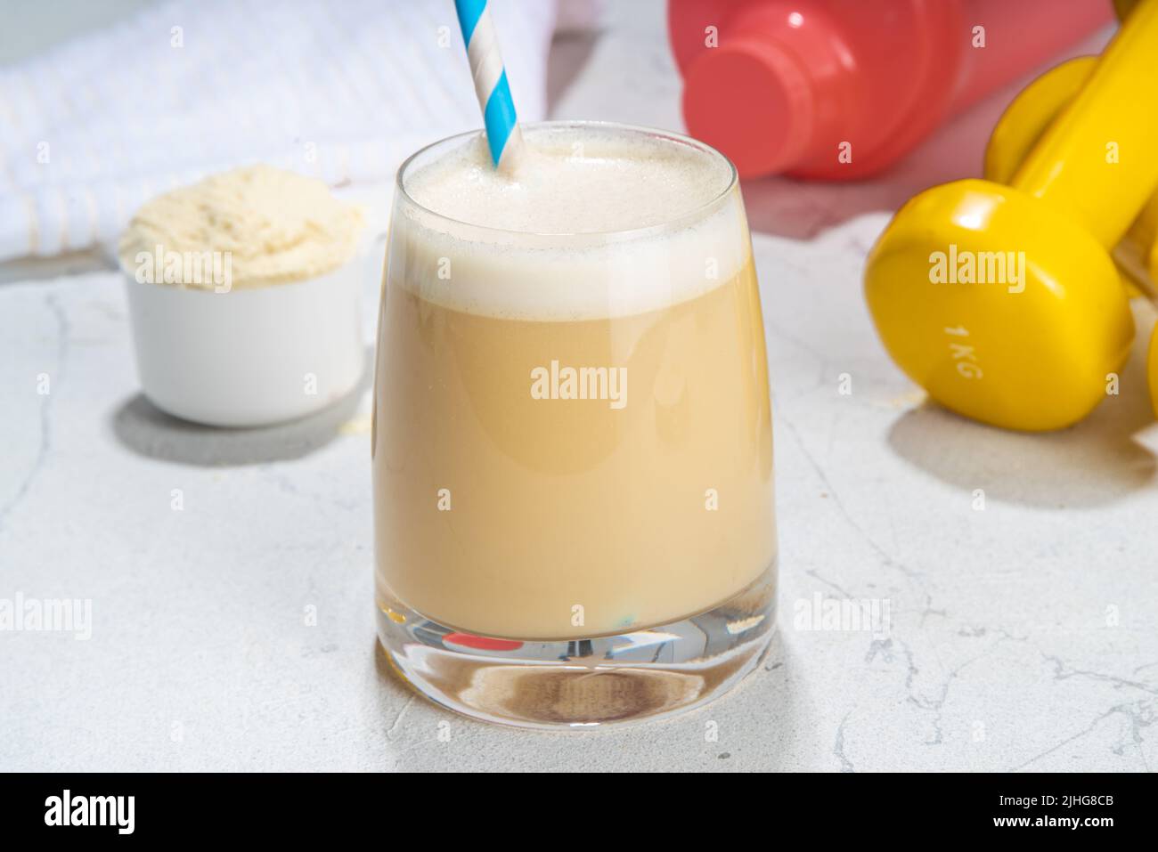Vanilla White Protein Shake Glass With Straw With Protein Powder Dumbbell Towel And Fitness