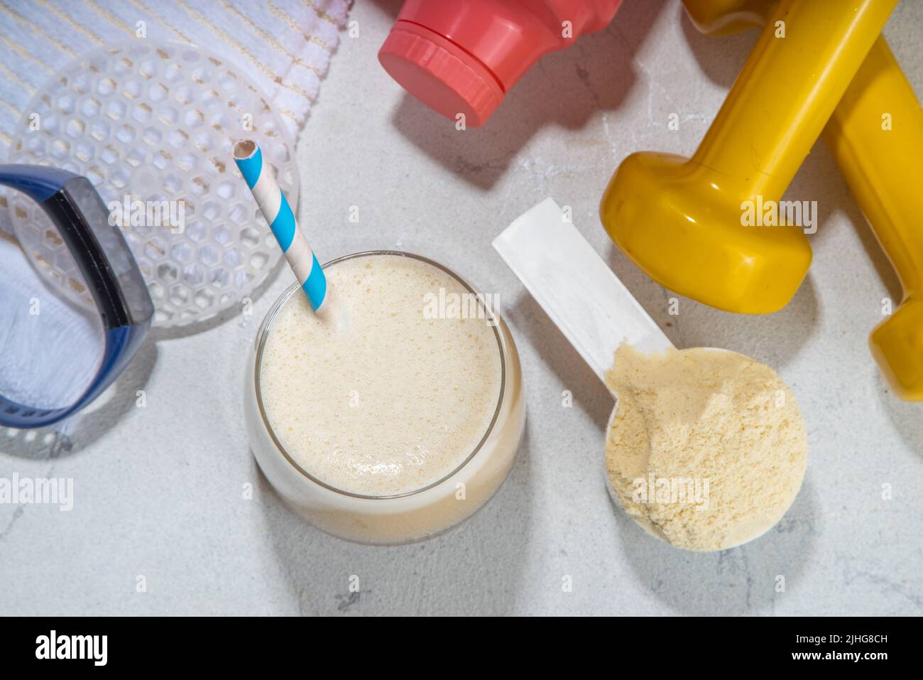 Vanilla White Protein Shake Glass With Straw With Protein Powder Dumbbell Towel And Fitness