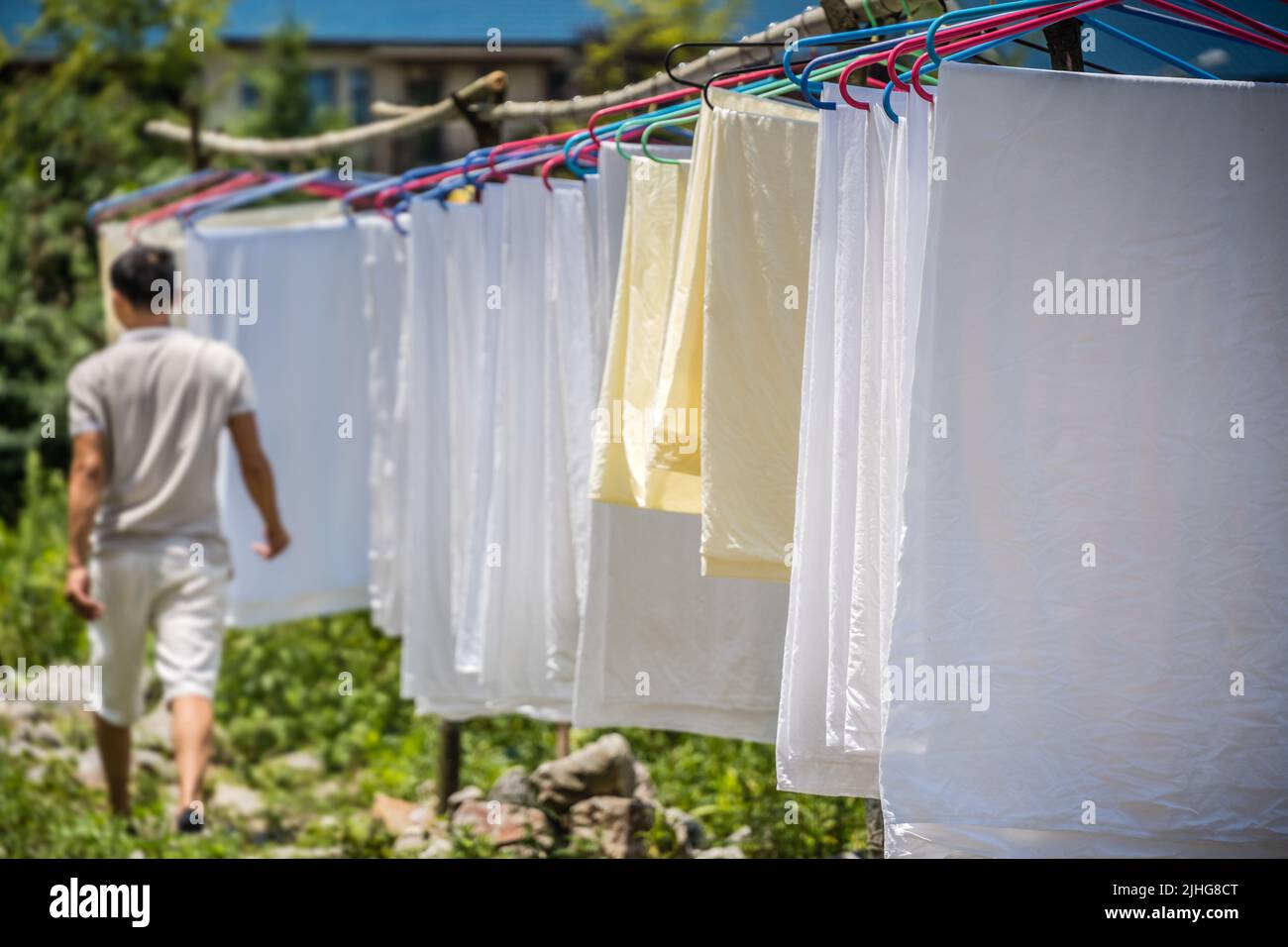 Wulong, China - August 2019 : Chinese man working in a hotel hanging ...