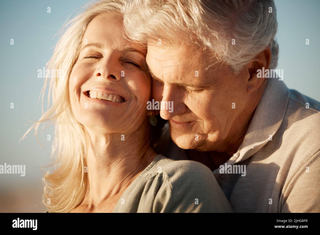 Mature husband hugging his wife on holiday. Senior couple enjoying a ...