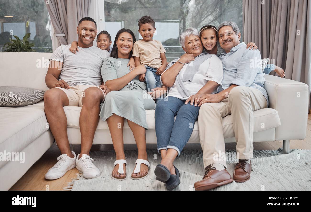 Happy and affectionate young mixed race family of seven sitting on a ...