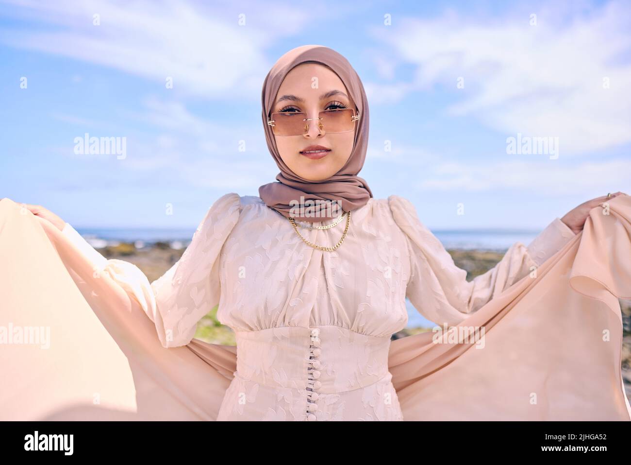 Beautiful young arab woman posing outdoors in a headscarf. Attractive ...