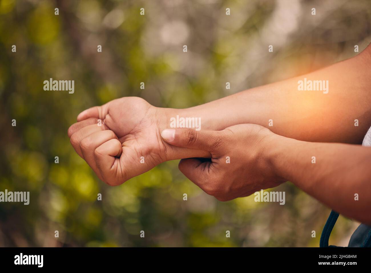 Closeup of a man suffering with wrist pain while out hiking in the ...