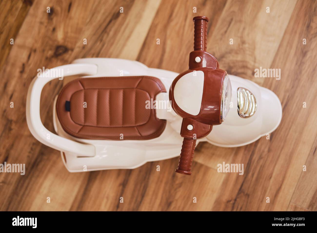 Plastic children motorcycle riding in the playroom, toy brown moped for ...