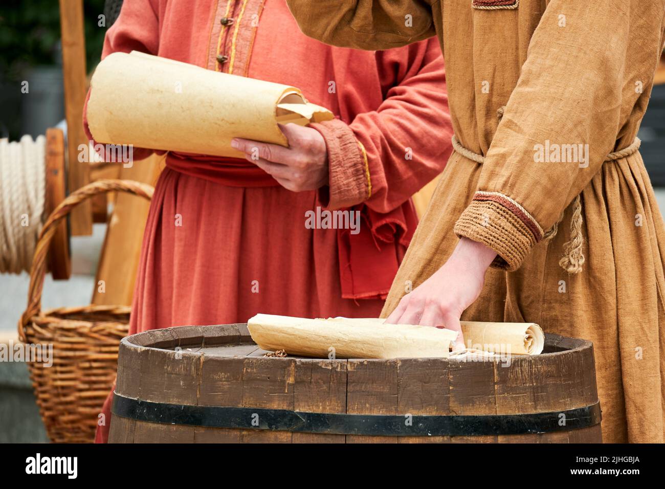 A man in vintage medieval clothes with a paper letter in his hand ...