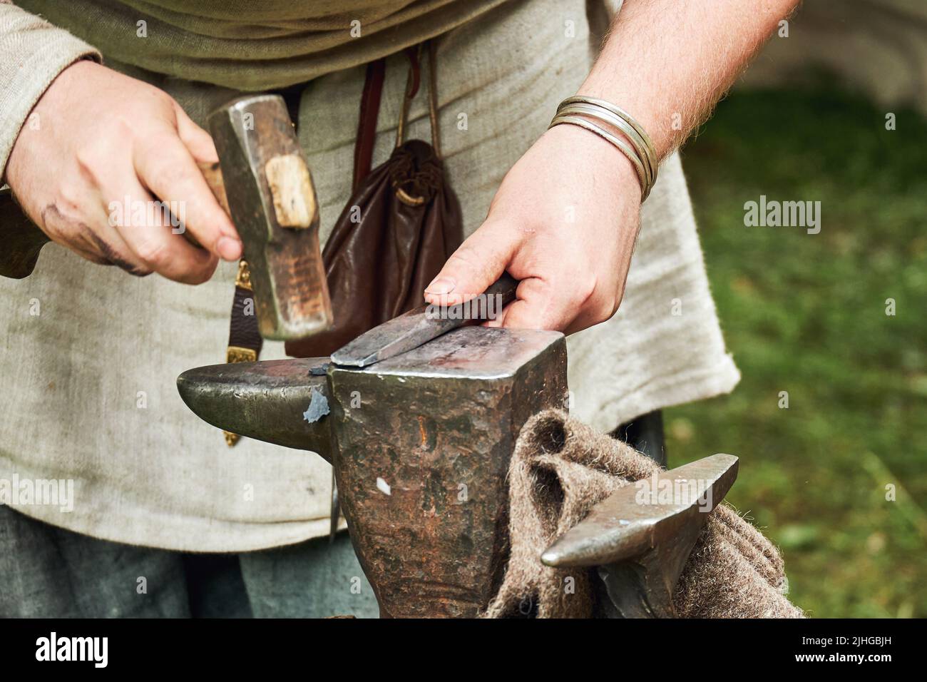 Work of a medieval blacksmith for the manufacture of metal products ...