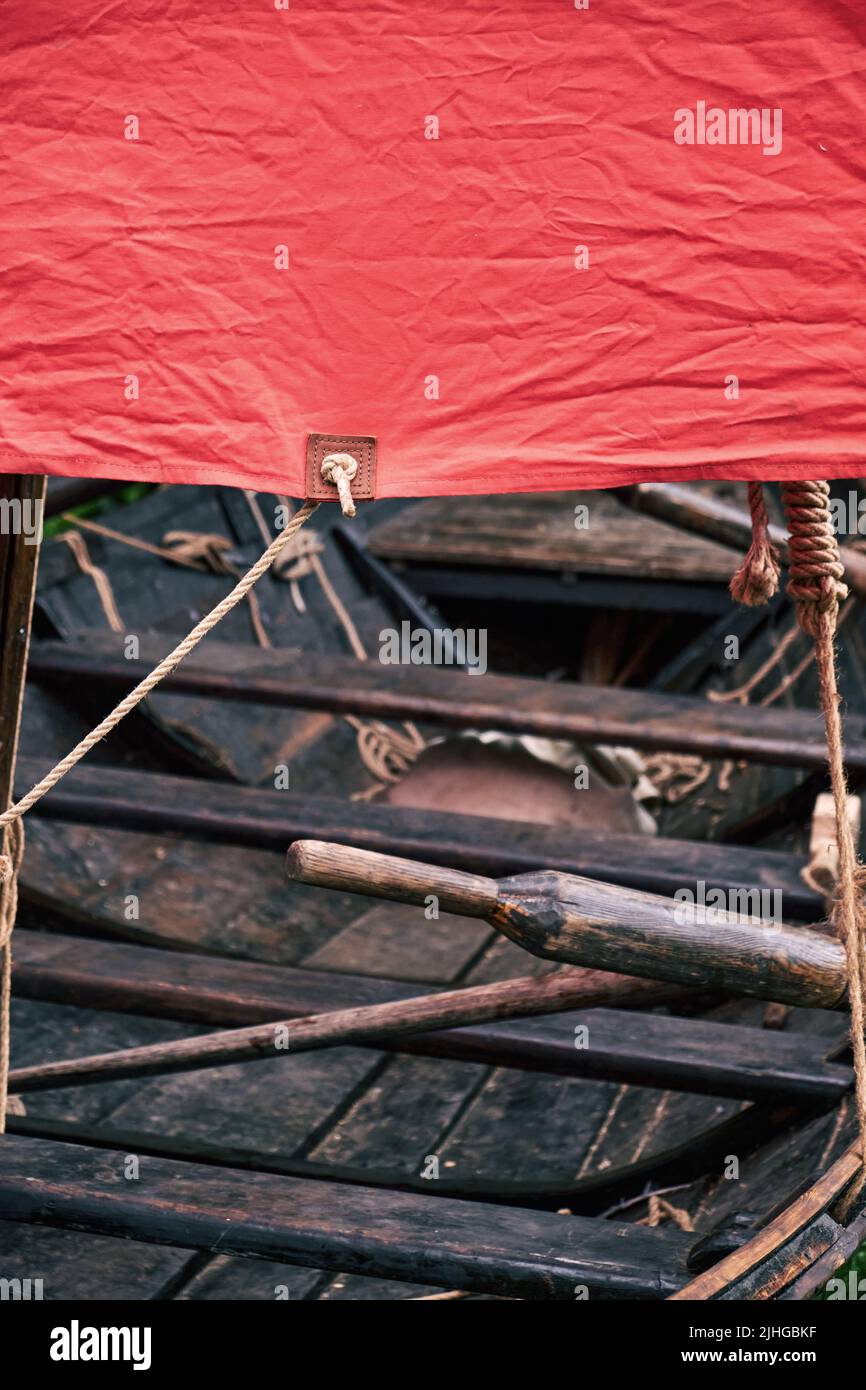 Medieval wooden ship, sailboat with a red sail. Reconstruction of the ...