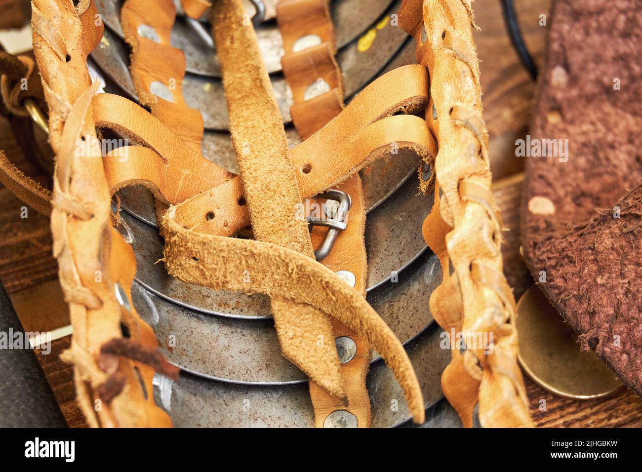 Leather strap on the armor of a Roman soldier, close-up. Reconstruction ...