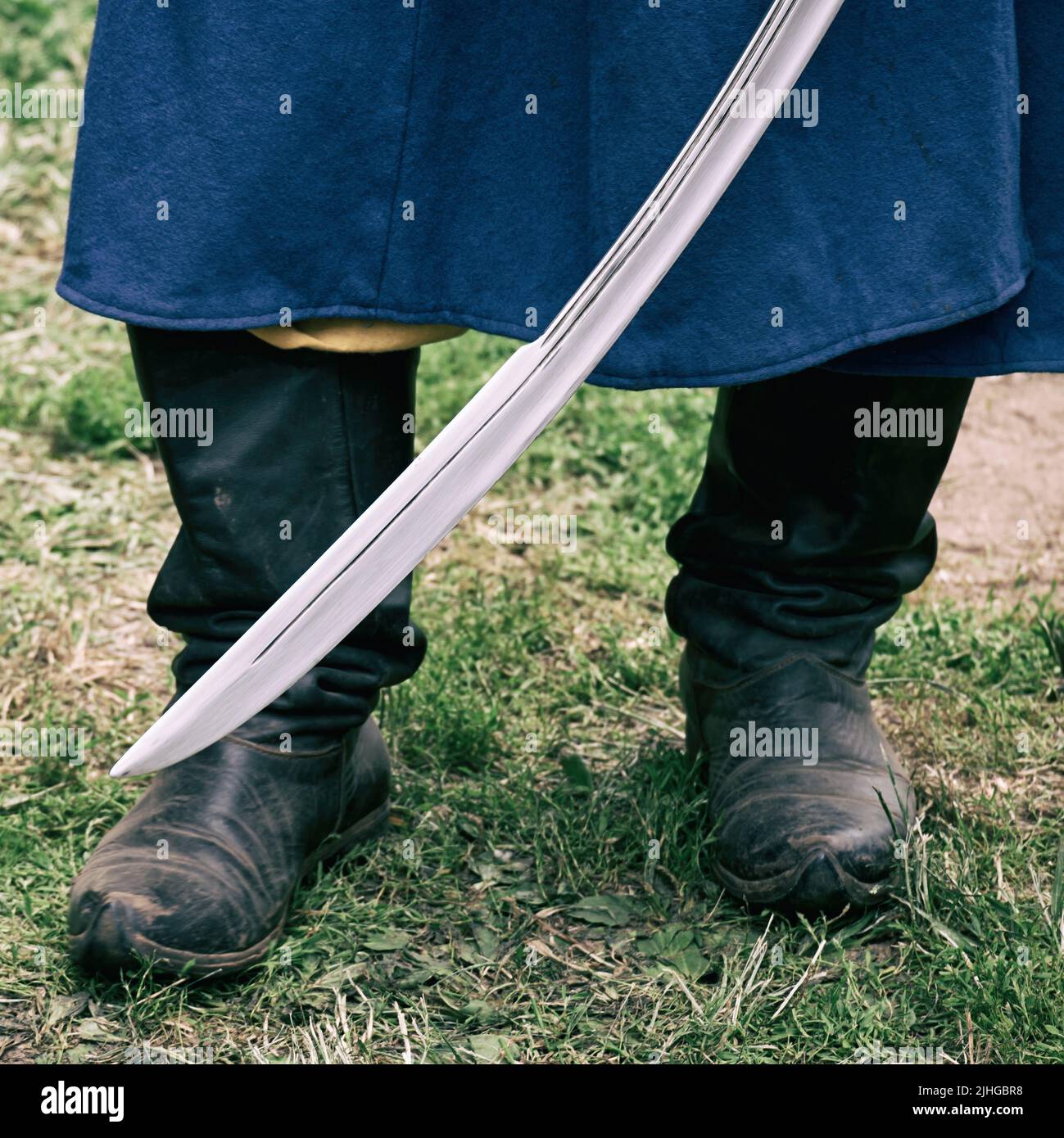 A man in a vintage Swedish military uniform with a saber in his hands ...