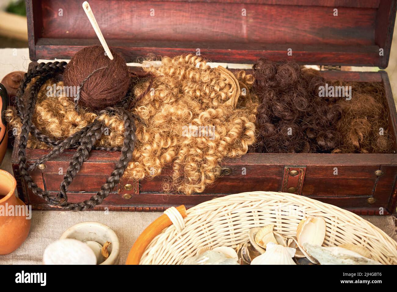 Ancient Roman woman wigs, retro ball of wool with a needle and vintage ...