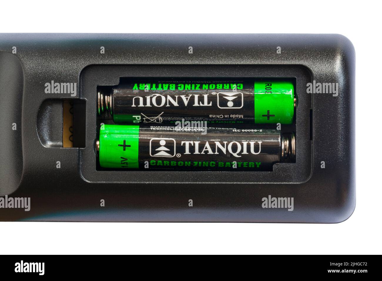 Two AAA Tianqiu carbon zinc batteries in remote control set on white ...