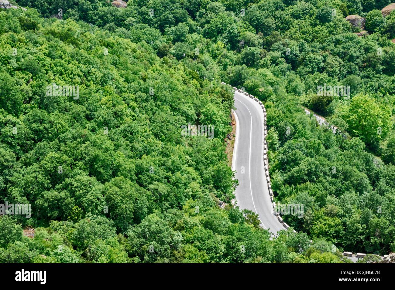 Country road through wooded area viewed from above Stock Photo - Alamy