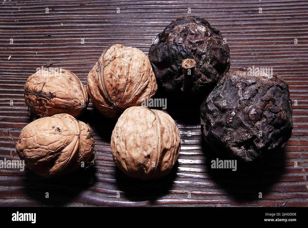 Walnuts on a peeled tree and peeled collected Stock Photo - Alamy