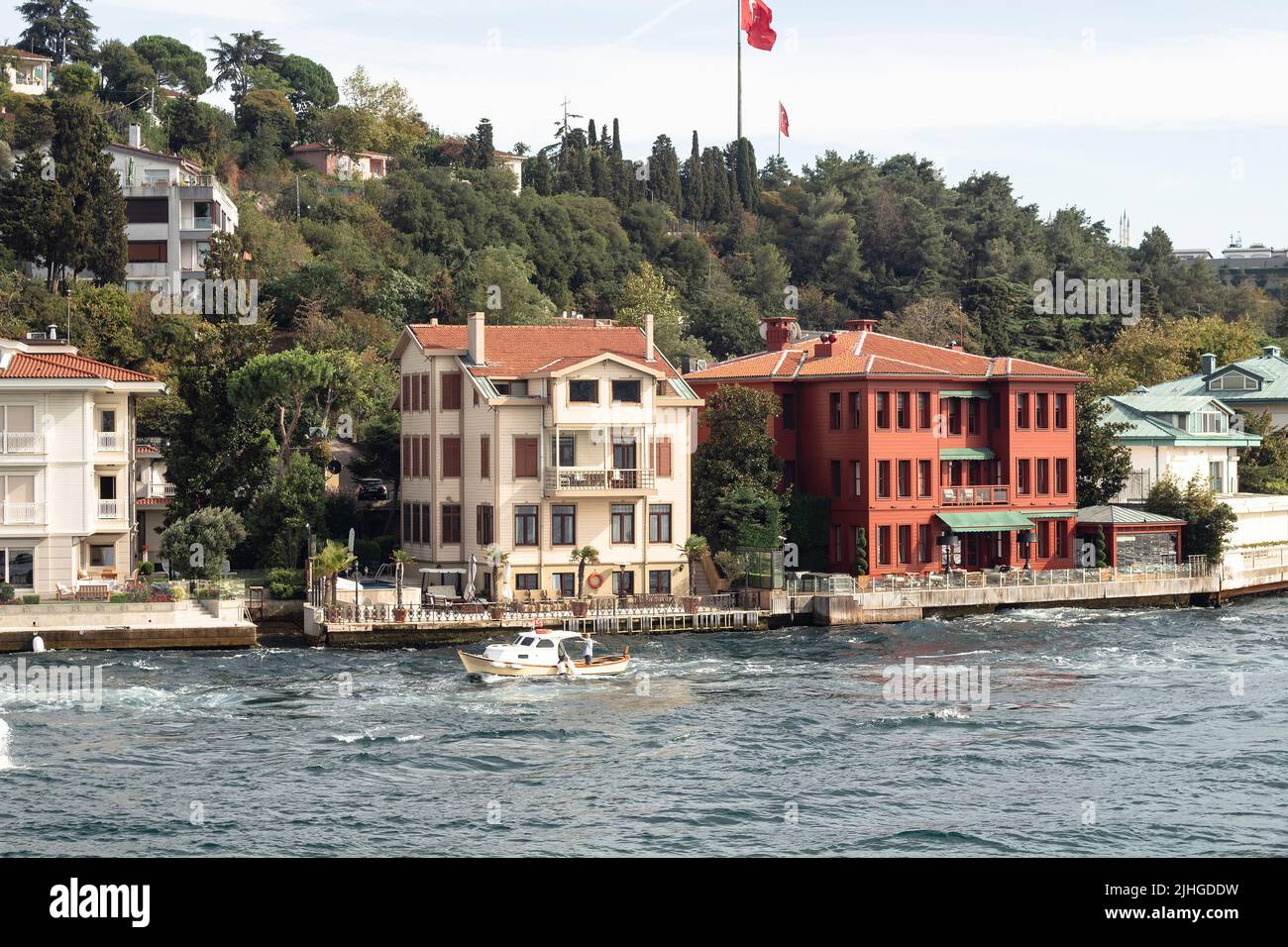 View of a small fishing boat on Bosphorus and historical and ...