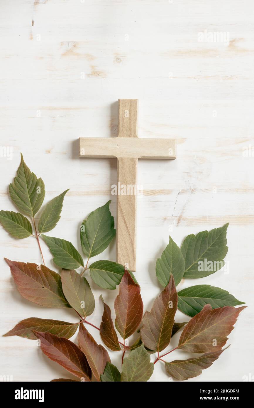 Simple Christian wood cross on a white wood background with a border of ...