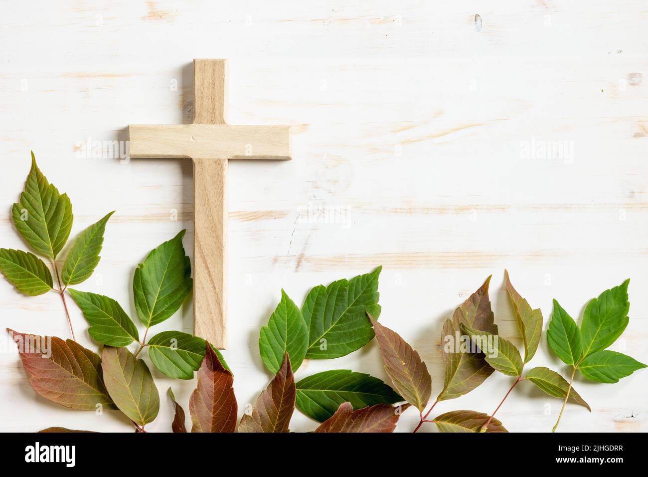 Simple Christian wood cross on a white wood background with a border of ...
