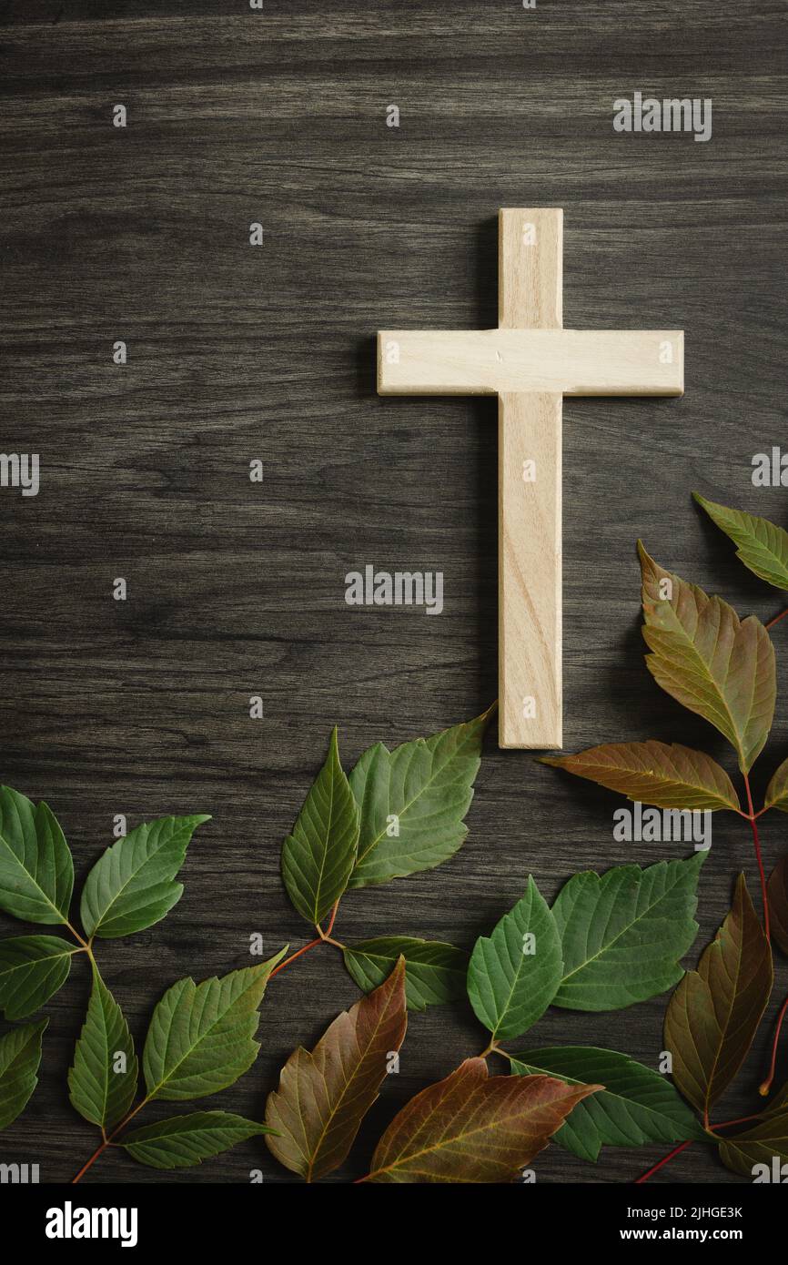 Small Christian cross on a dark wood background with a border of ...
