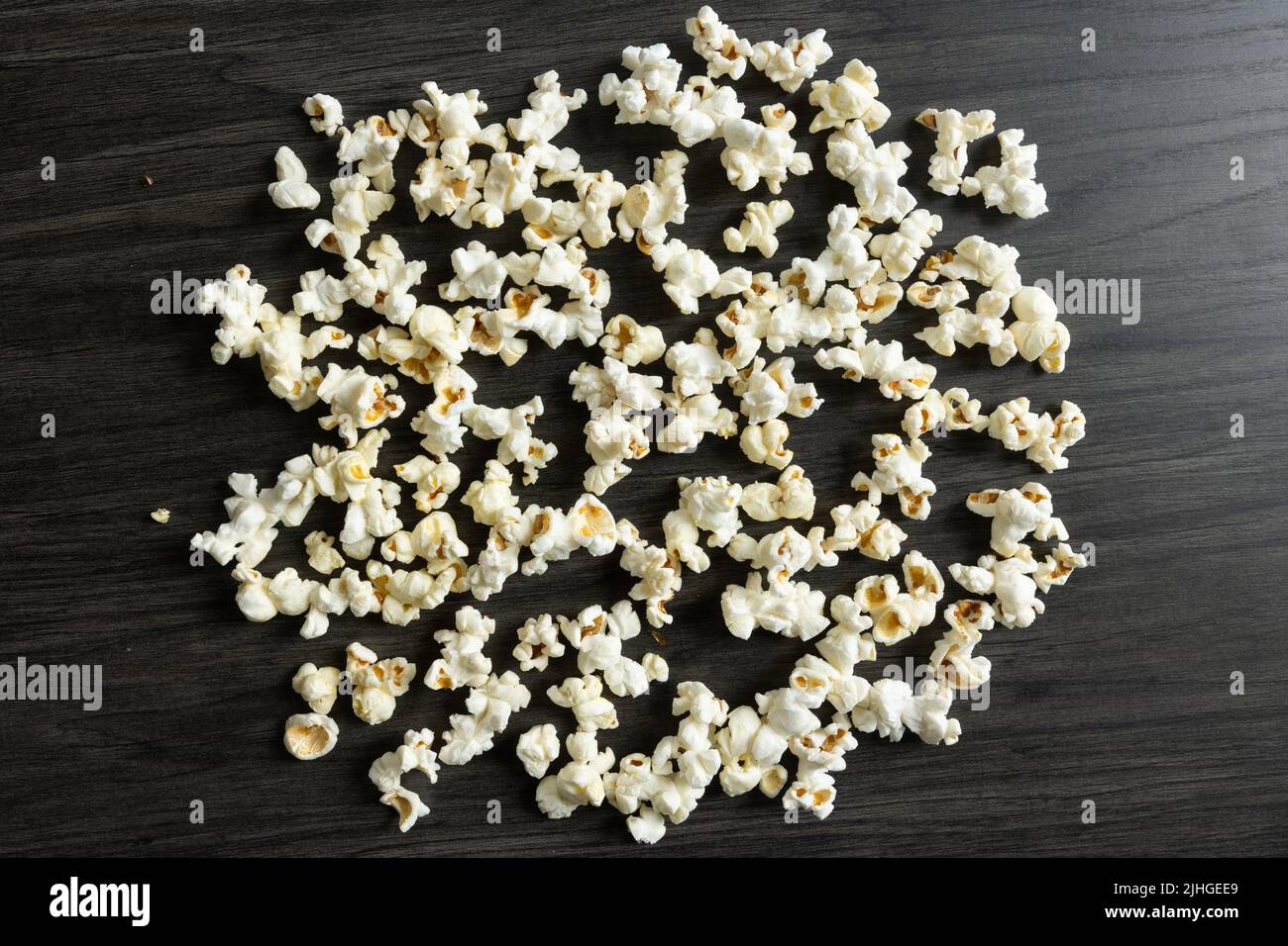 Background of freshly popped popcorn on a dark wood background with ...
