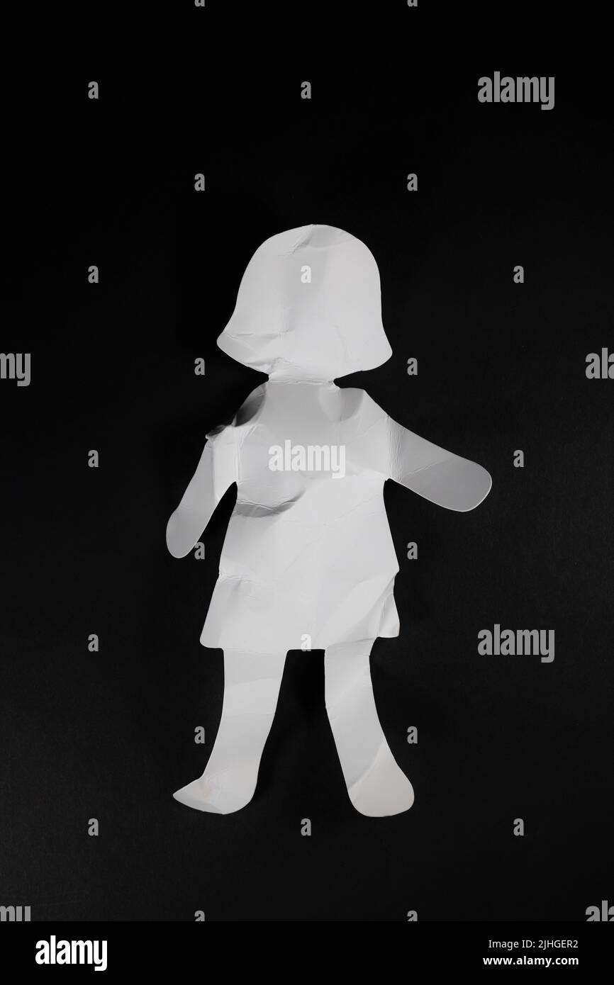 A white paper crumpled cutout of a female Stock Photo - Alamy