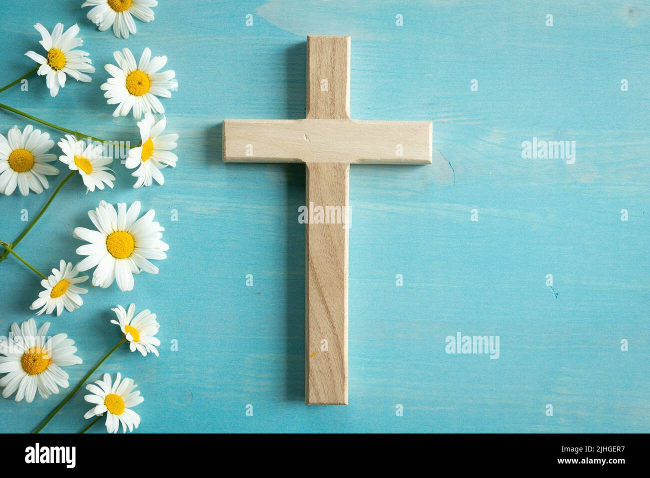 Simple wood Christian cross on a blue wood background with border of ... Simple wood Christian cross on a blue wood background with border of ...