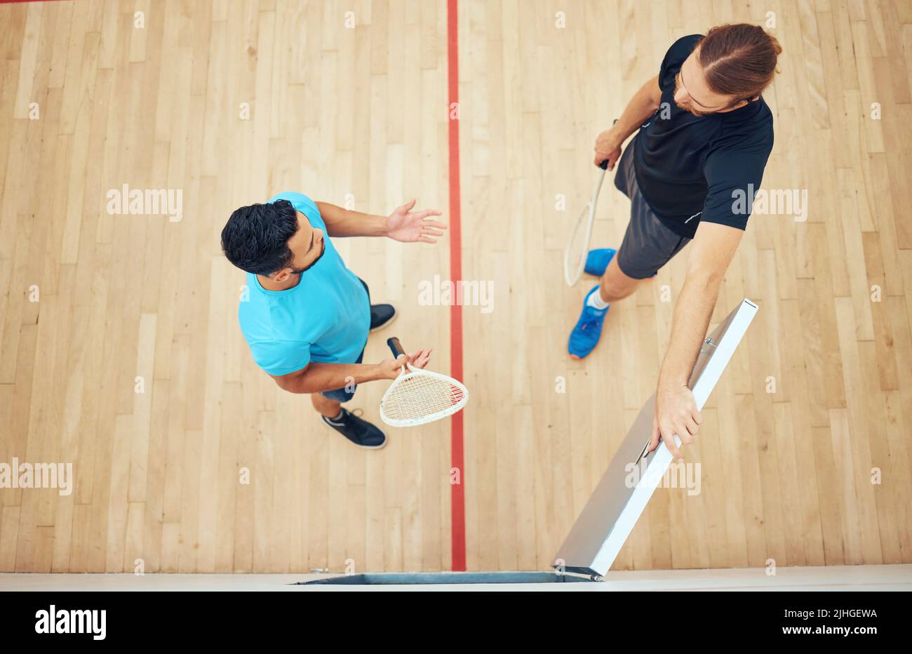 Above view of two unknown squash players standing together after ...