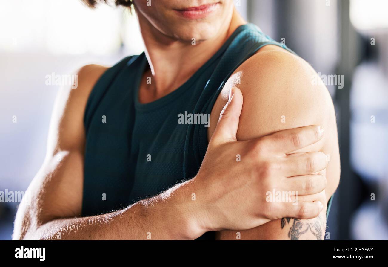 Closeup of one caucasian man holding his sore shoulder while training ...