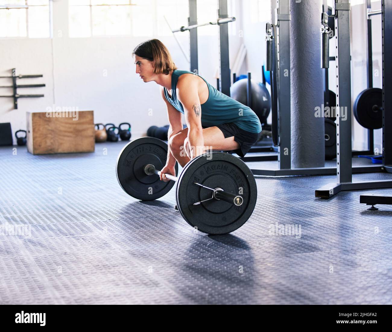 Focused man lifting heavy weights hi-res stock photography and images ...