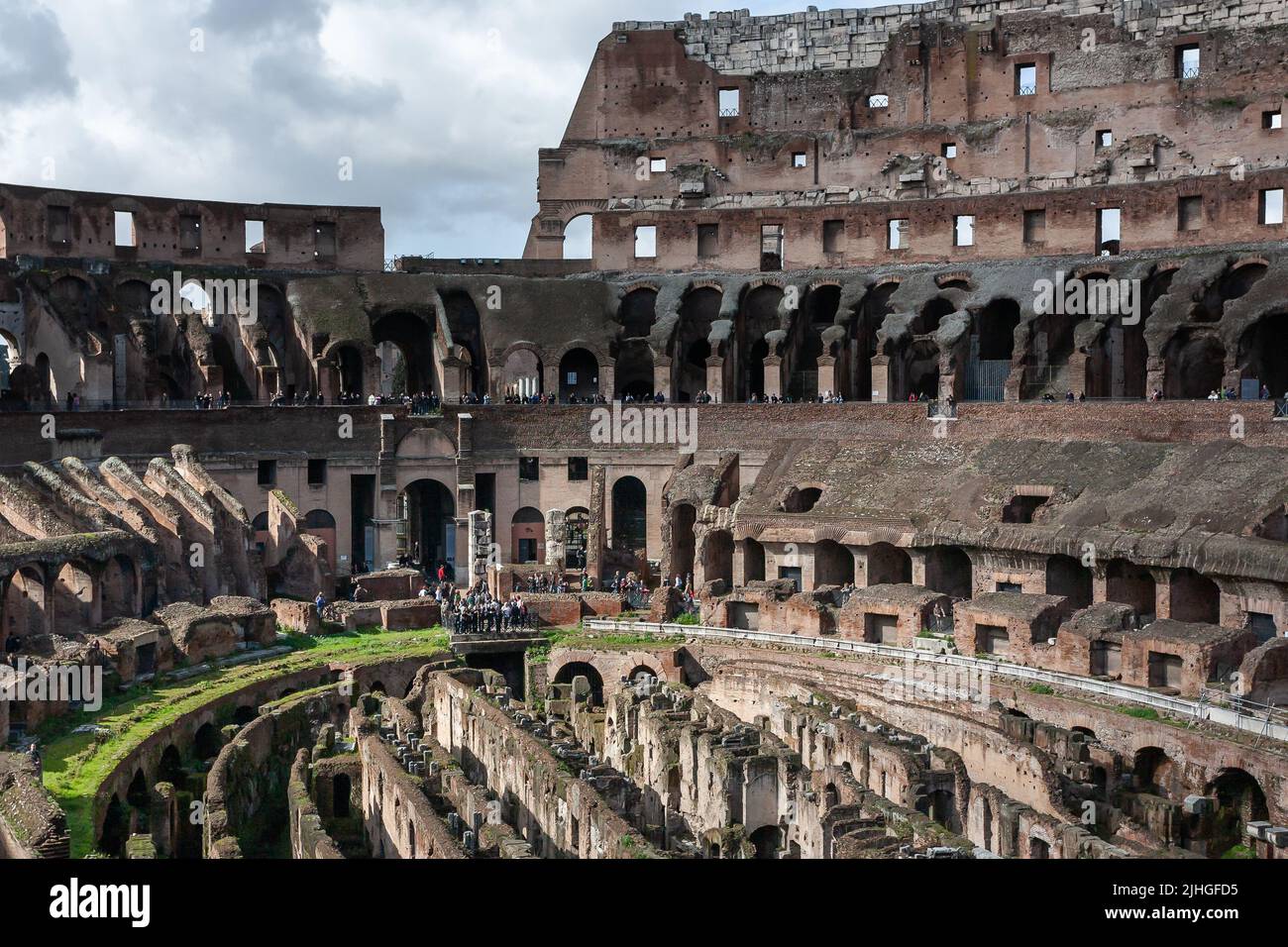 Tourists walking among the ruins of the Roman Colosseum, Rome, Italy ...