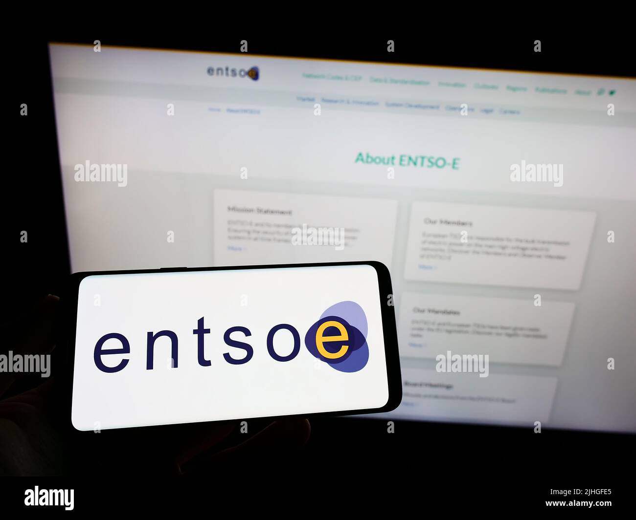 Person holding smartphone with logo of European energy association ...