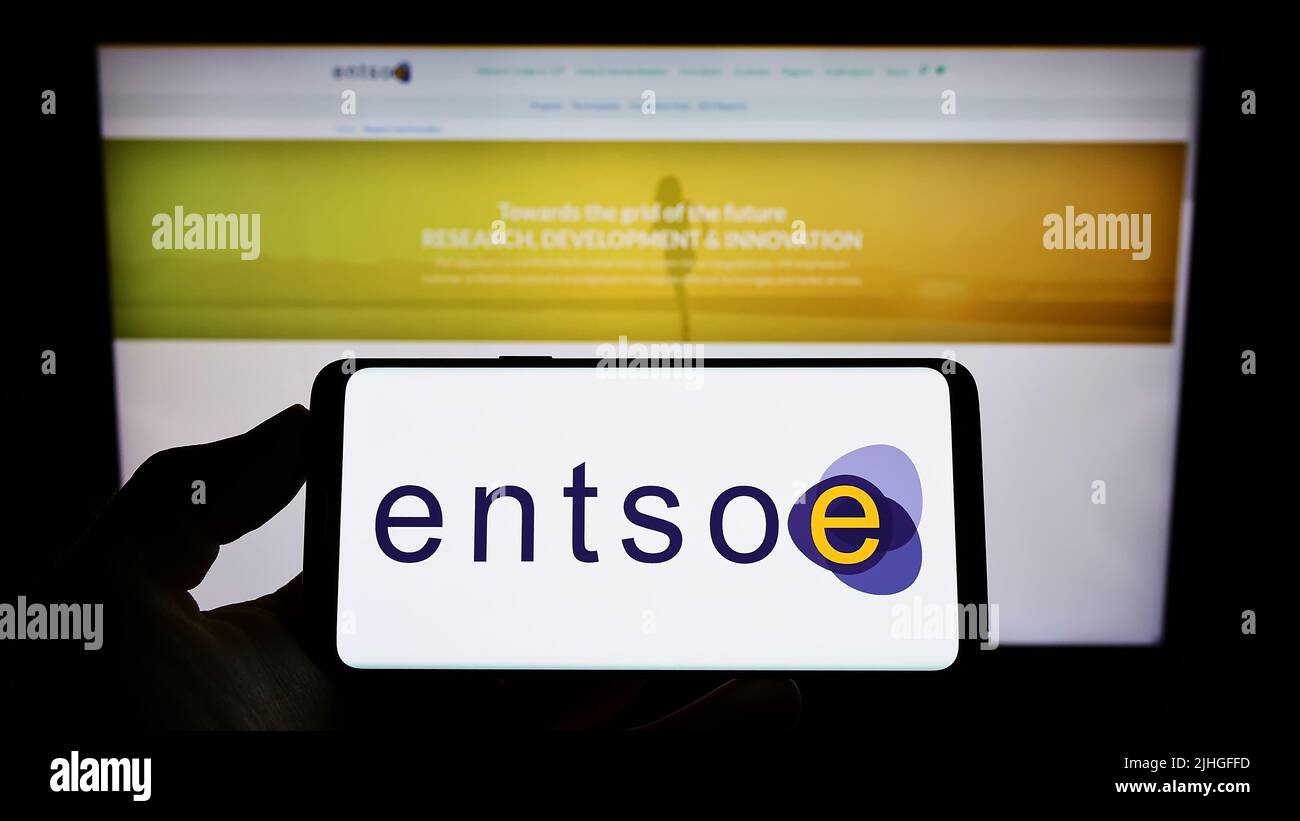 Person holding cellphone with logo of European energy association ENTSO ...