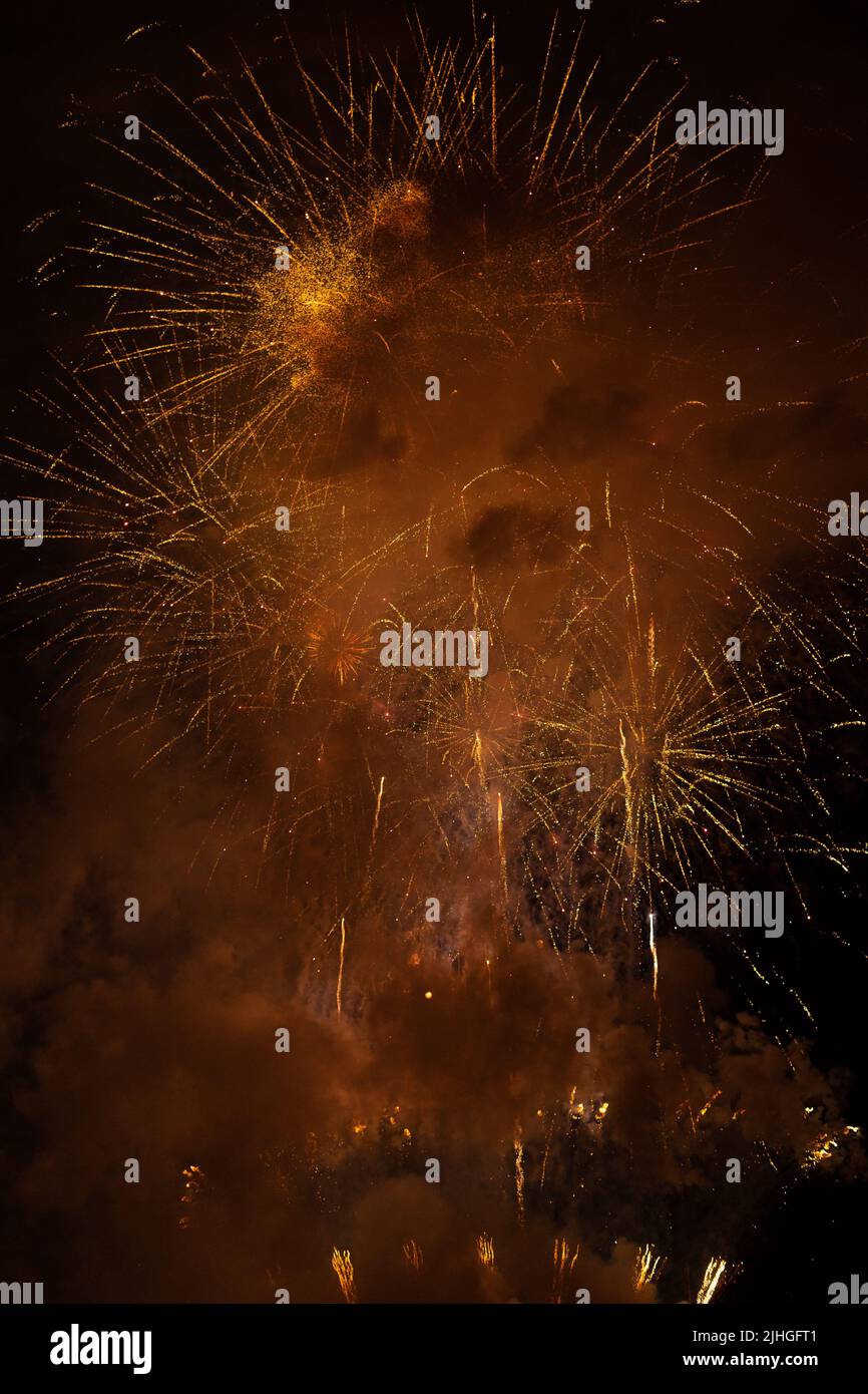 Fireworks exploding behind the smoke against black background Stock ...